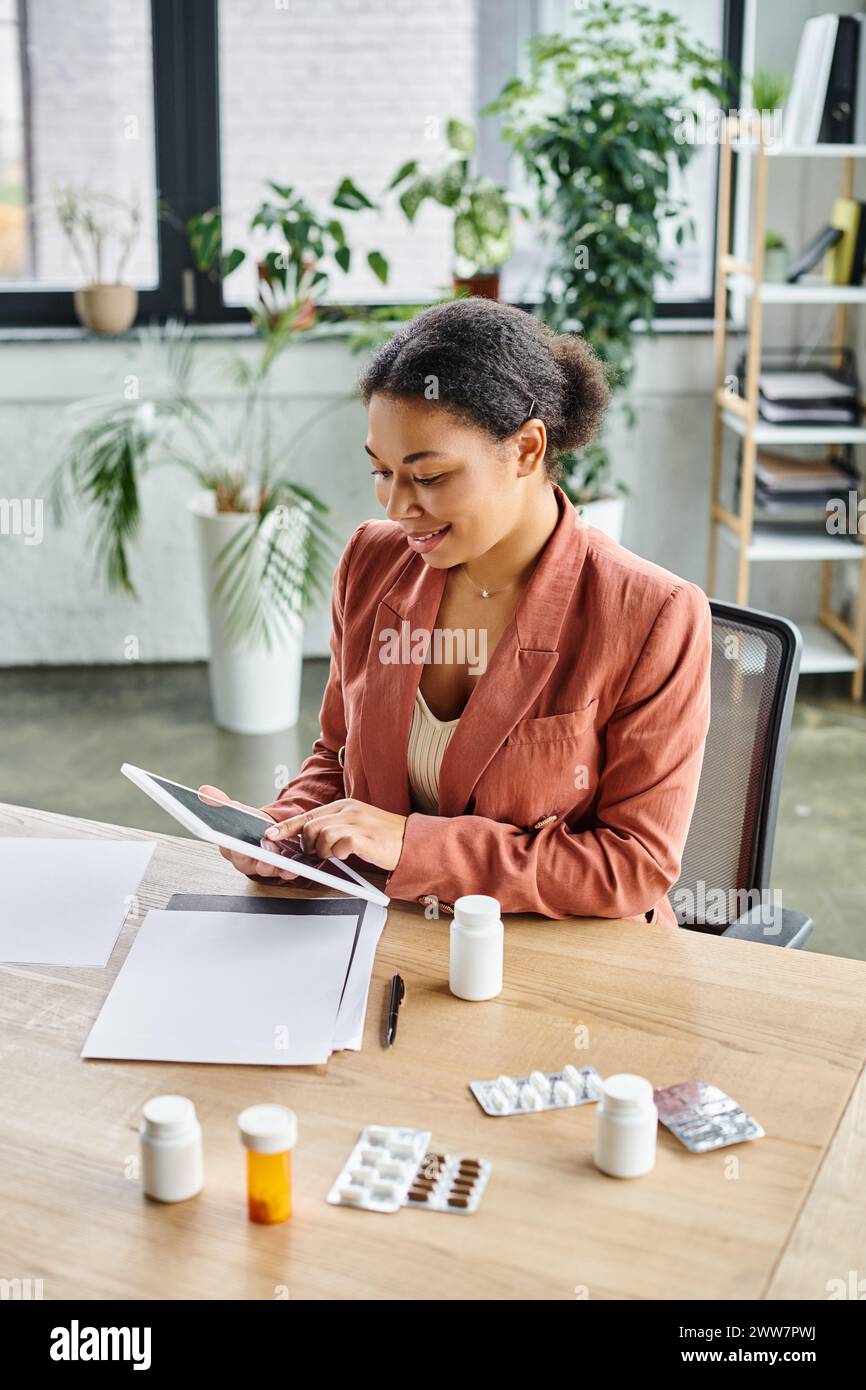 happy african american dietitian using tablet while organizing ...