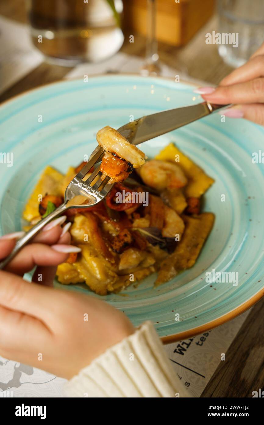 Female eating ravioli with shrimp with sour cream Stock Photo - Alamy