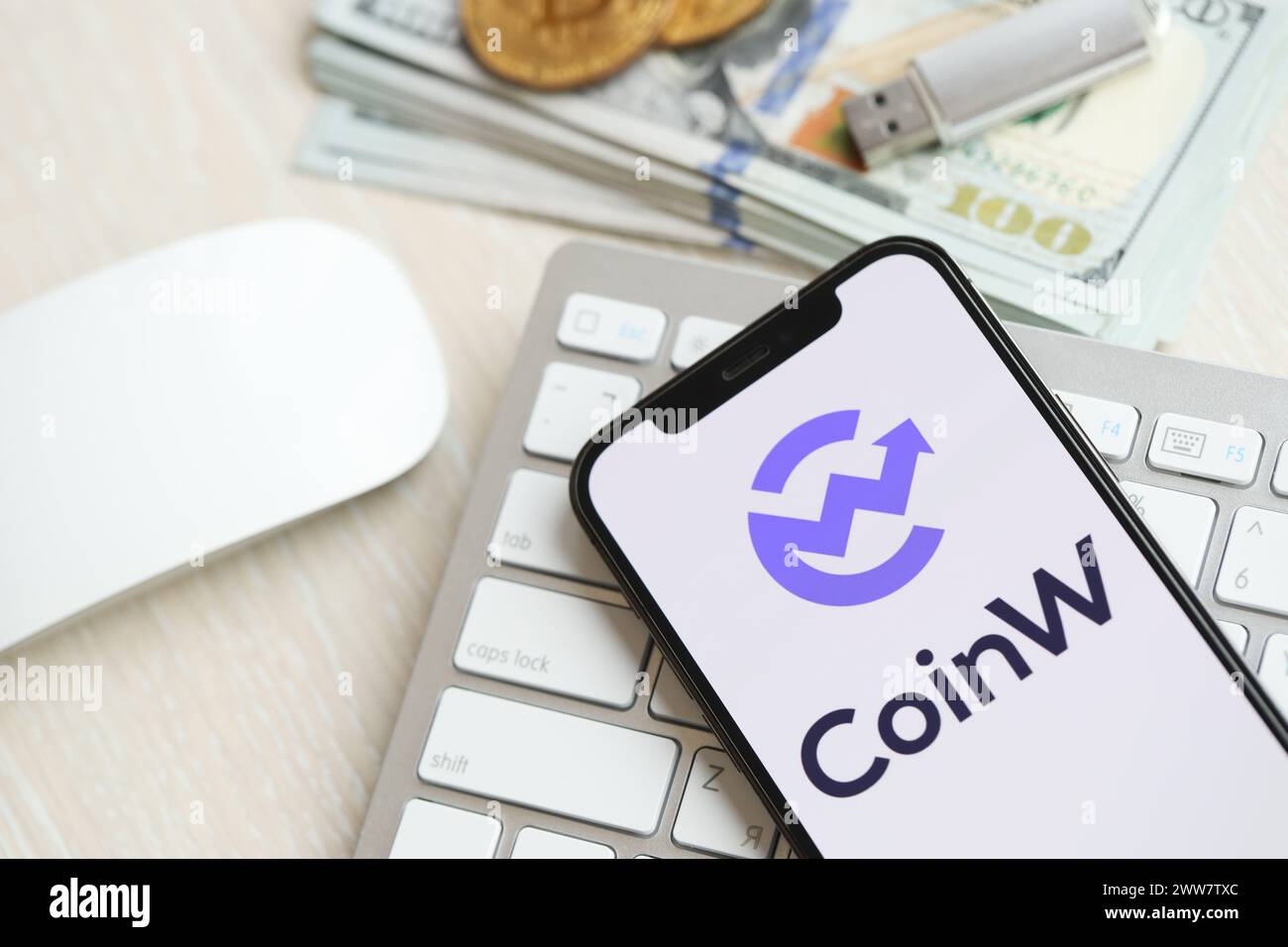 KYIV, UKRAINE - MARCH 15, 2024 CoinW logo on iPhone display screen on ...