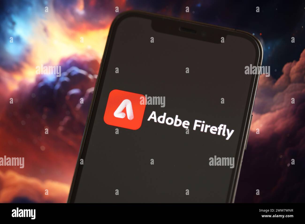 KYIV, UKRAINE - MARCH 17, 2024 Adobe Firefly logo on iPhone display screen with background of ...