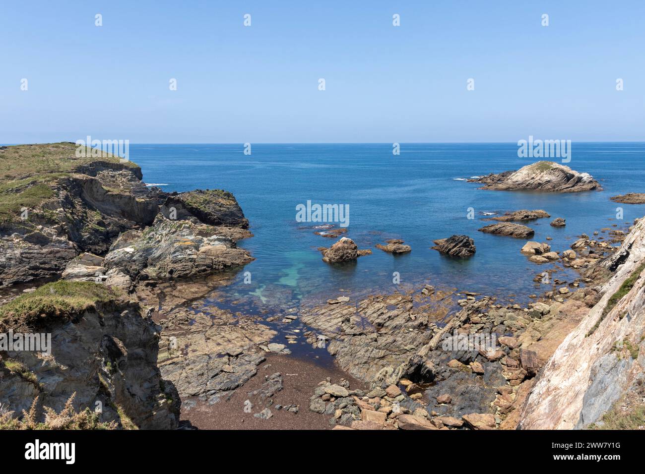 scenic coastline with rocky formations, blue waters, and distant ...