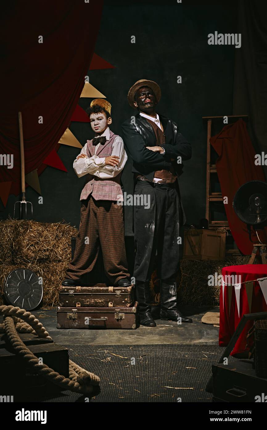 Retro-themed event. High African man standing with little servant boy ...