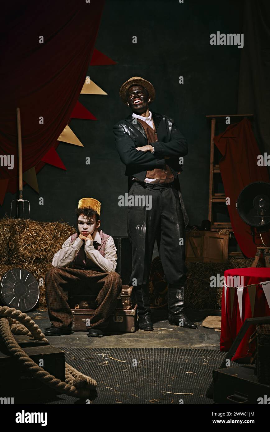 High African man with dirty face standing with little servant boy over ...