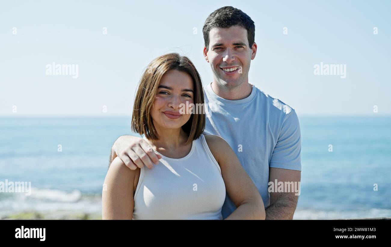 Beautiful couple smiling confident hugging each other at seaside Stock ...