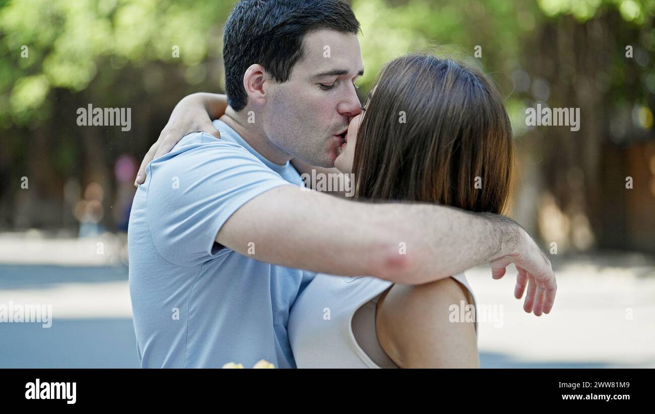 Beautiful couple hugging each other kissing at park Stock Photo - Alamy