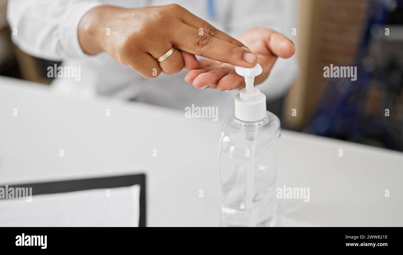 A person dispensing sanitizer indoors for hygiene in a potential ...