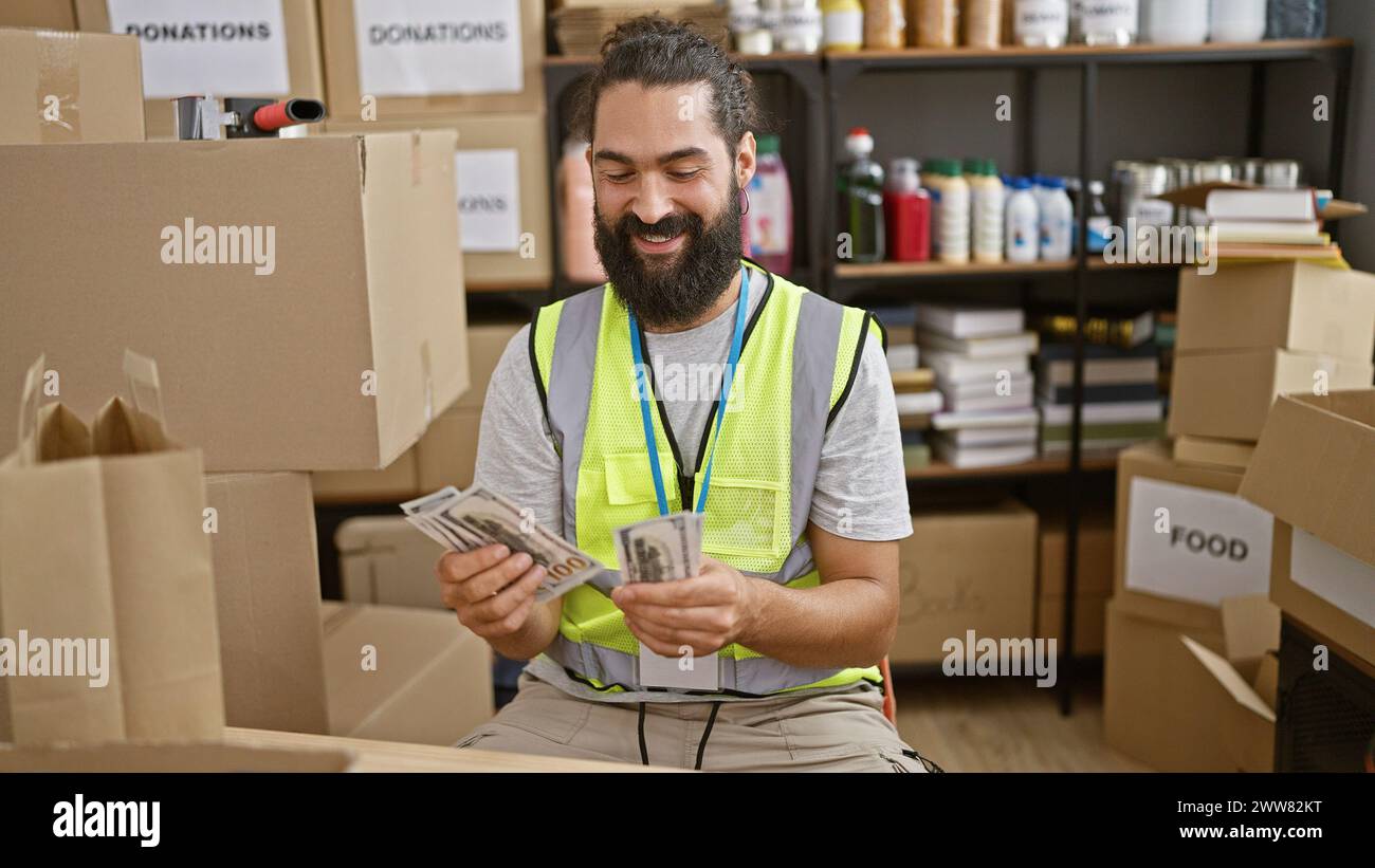 Smiling hispanic man counting money inside a donation center surrounded ...
