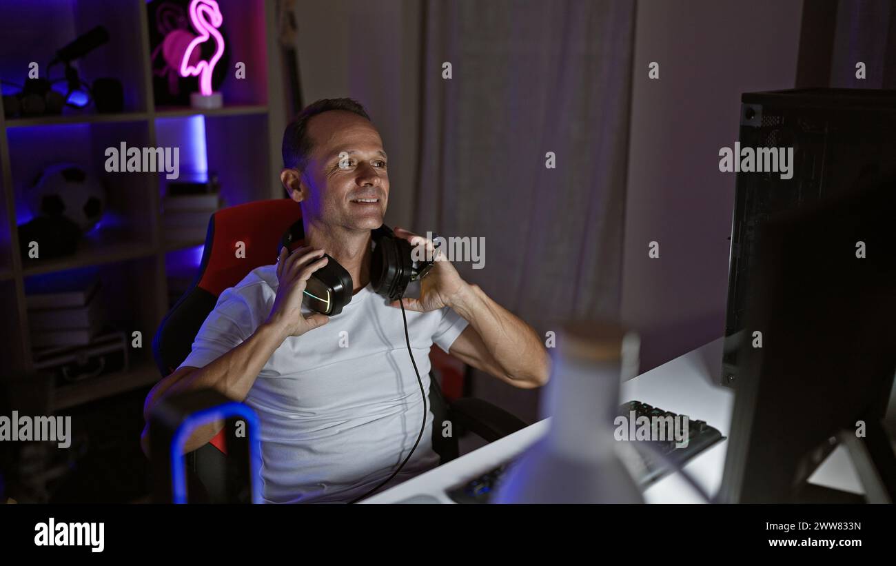 Handsome middle-aged streamer, rocking his gaming gadgets in his ...