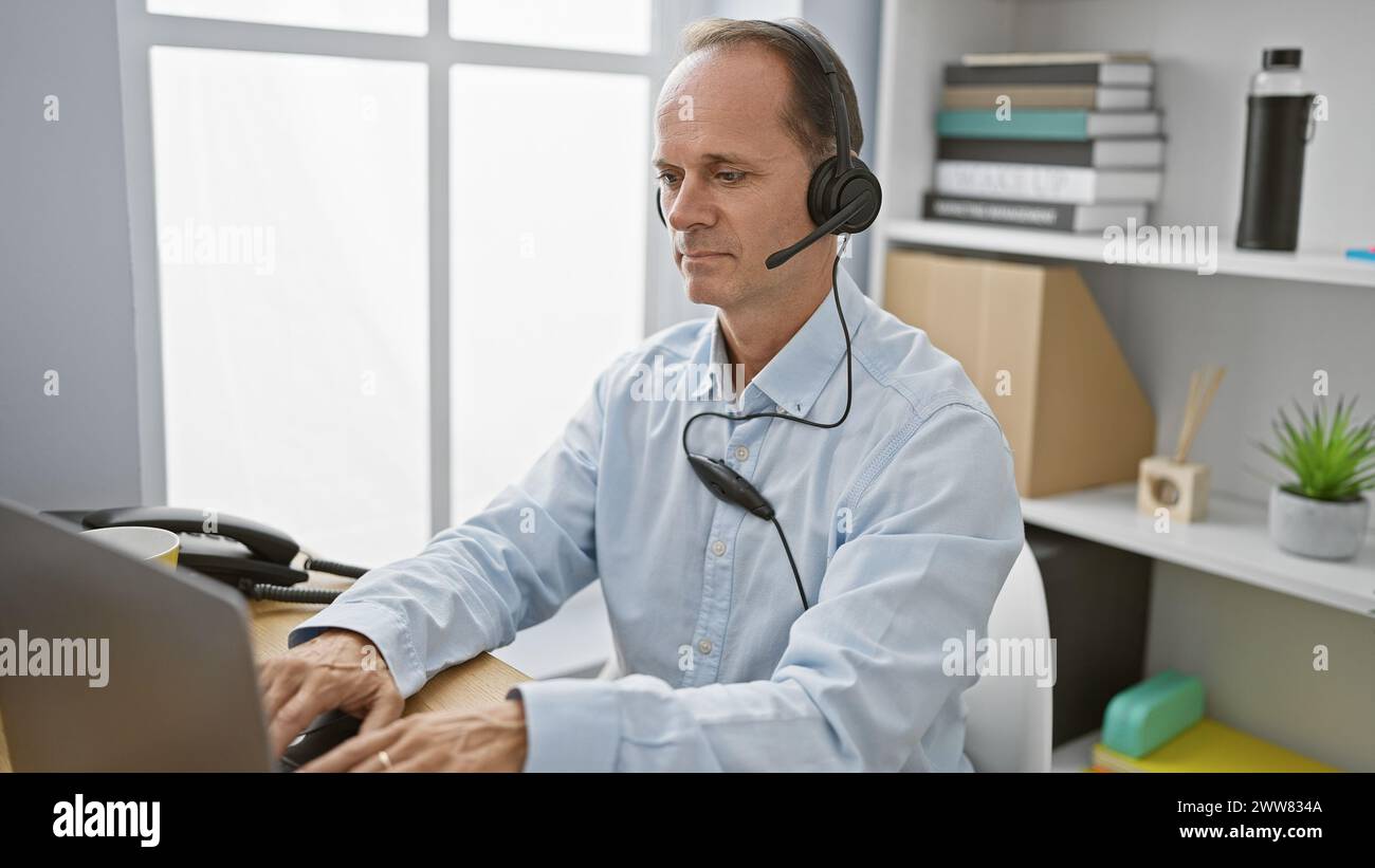 Mature, handsome hispanic business man, working hard at the office ...