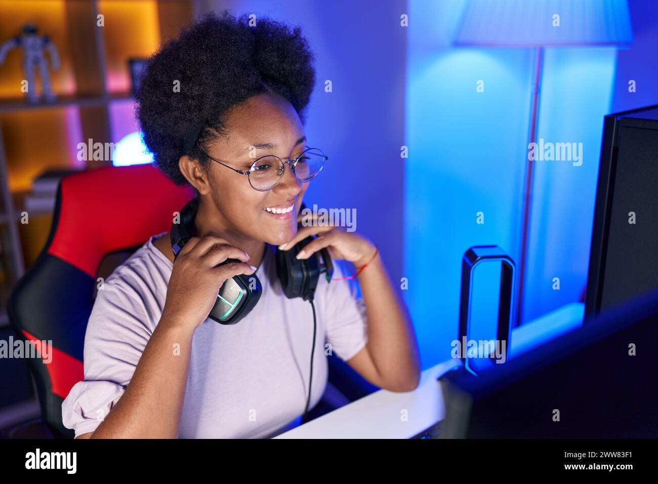African american woman streamer smiling confident sitting on table at ...