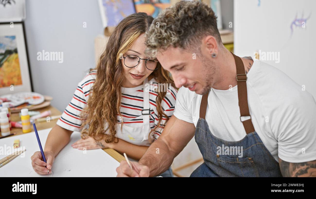 A man and woman as artists collaborate in a creative studio environment ...