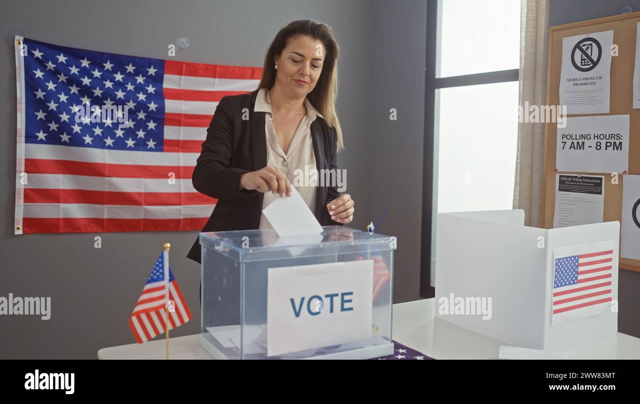 Hispanic woman voting indoors at an electoral college in the united ...