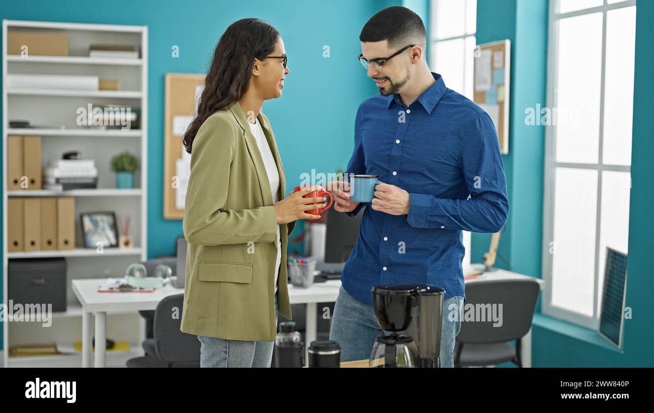 Two workers, a confident man and an elegant woman, enjoying their ...