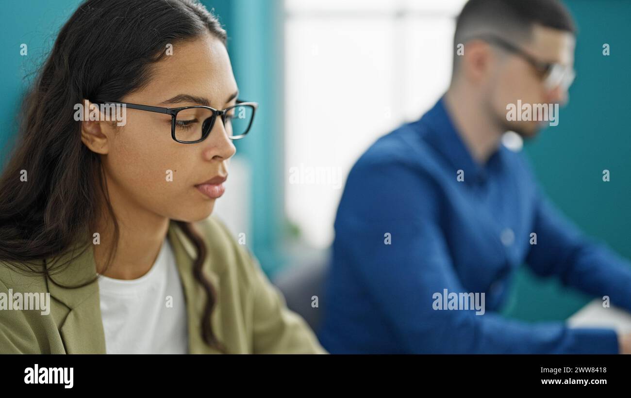 Two professional workers, man and woman, laser-focused on success ...