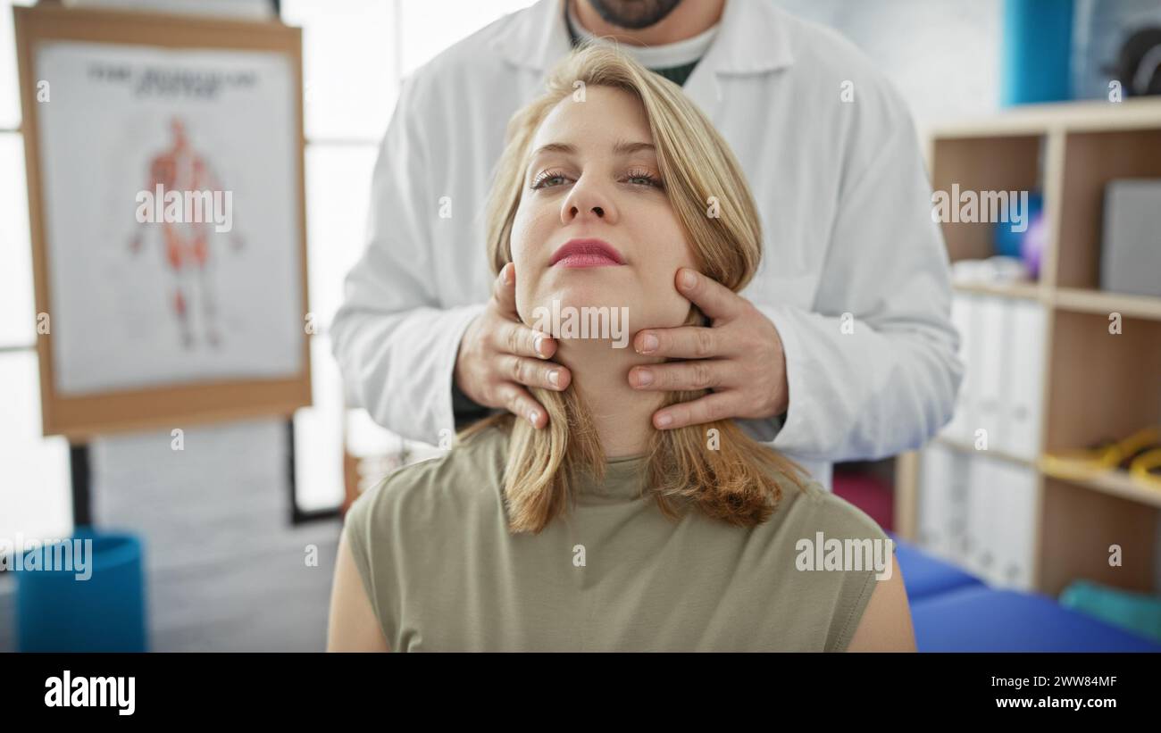 A woman receives a careful neck examination from a male physiotherapist ...