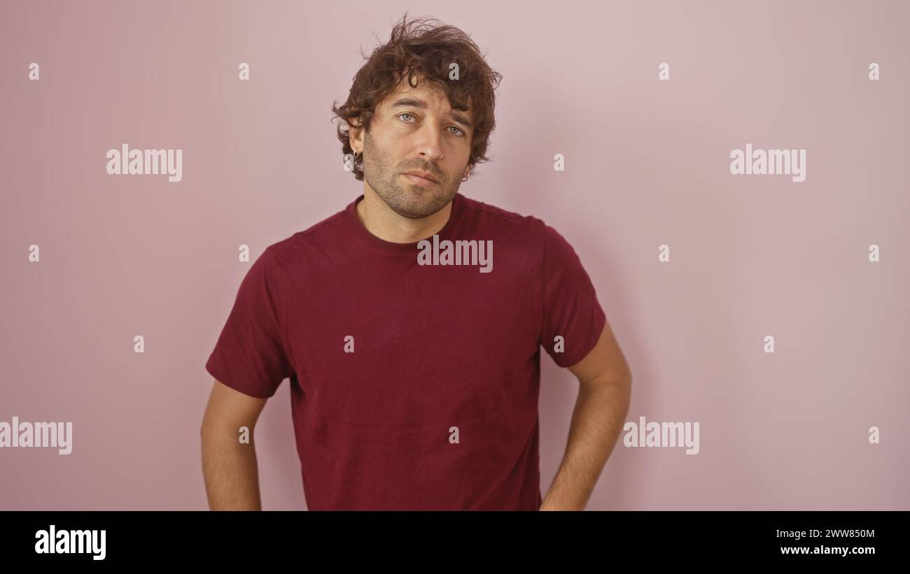 Handsome young hispanic man with a beard standing against an isolated ...