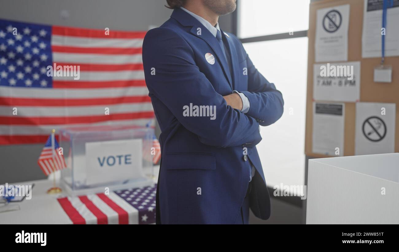 A young hispanic man with arms crossed stands proudly in a voting ...