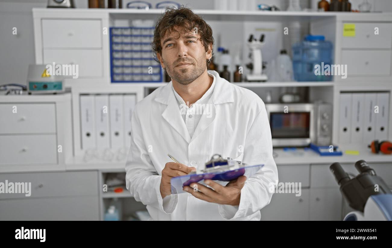 A handsome man with a beard and green eyes wearing a lab coat stands ...
