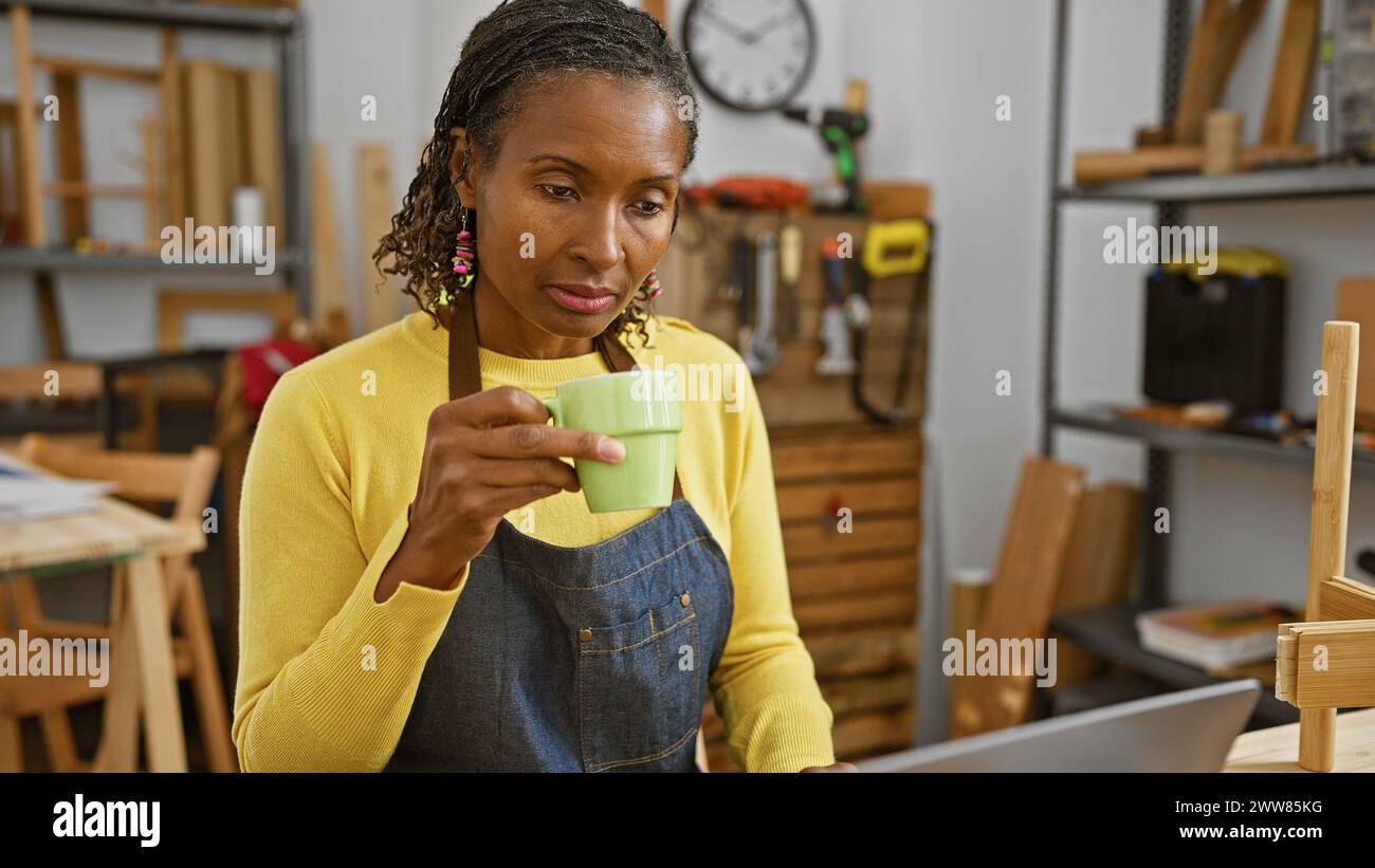 African american woman enjoying a coffee break in her carpentry ...