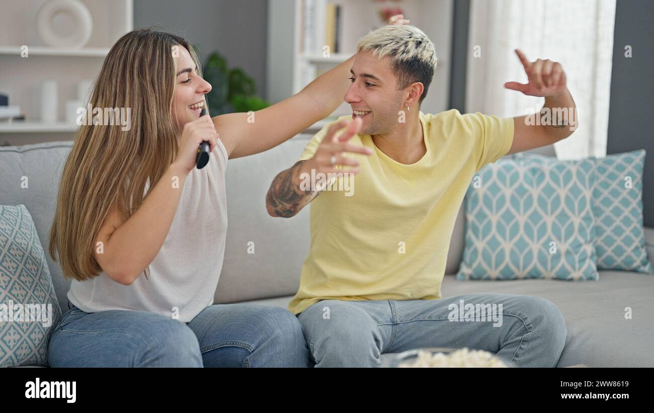 Beautiful couple singing song using remote control as a microphone at ...