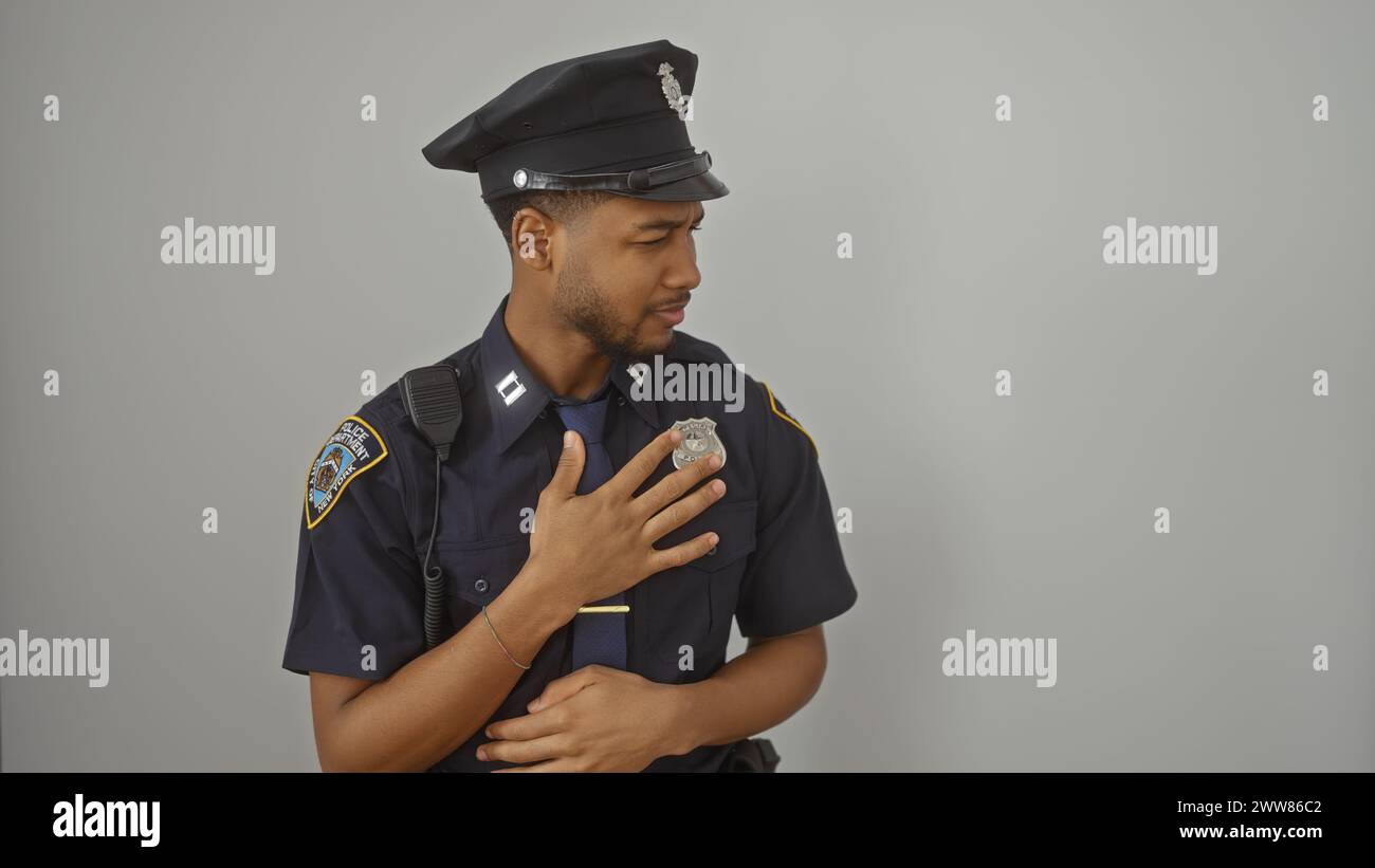 African american police officer saluting with pride against a plain ...