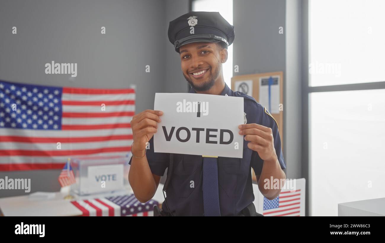 An african american police officer smiling while holding an 'i voted ...
