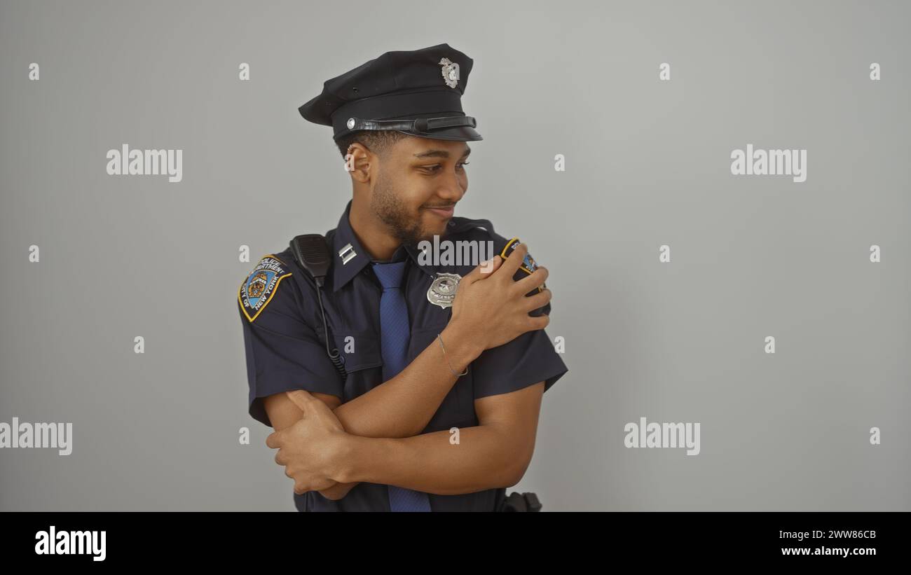 African american police officer smiling against a white background in a ...