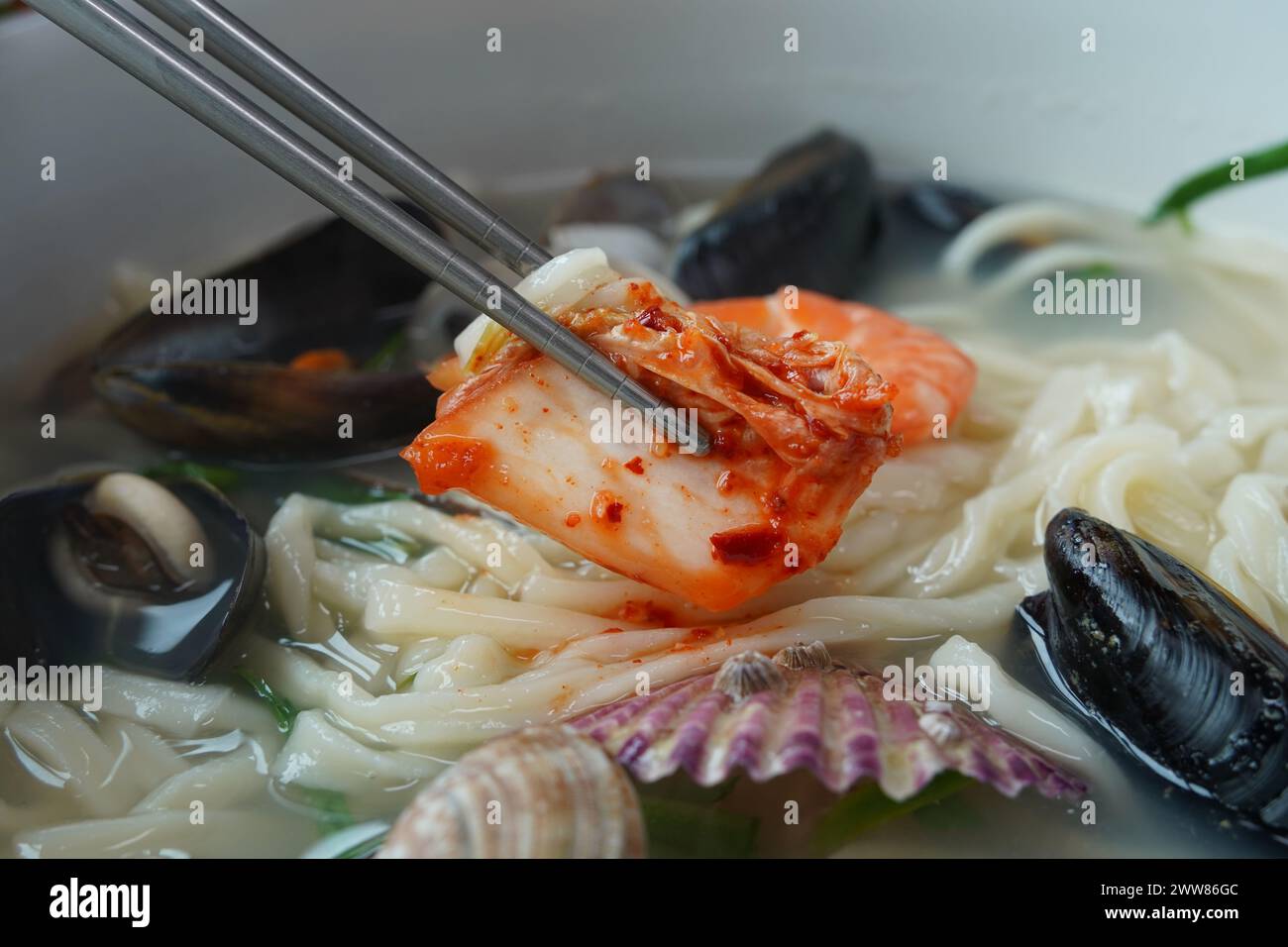 Kalguksu with seafood is made by boiling thin noodles with seafood ...