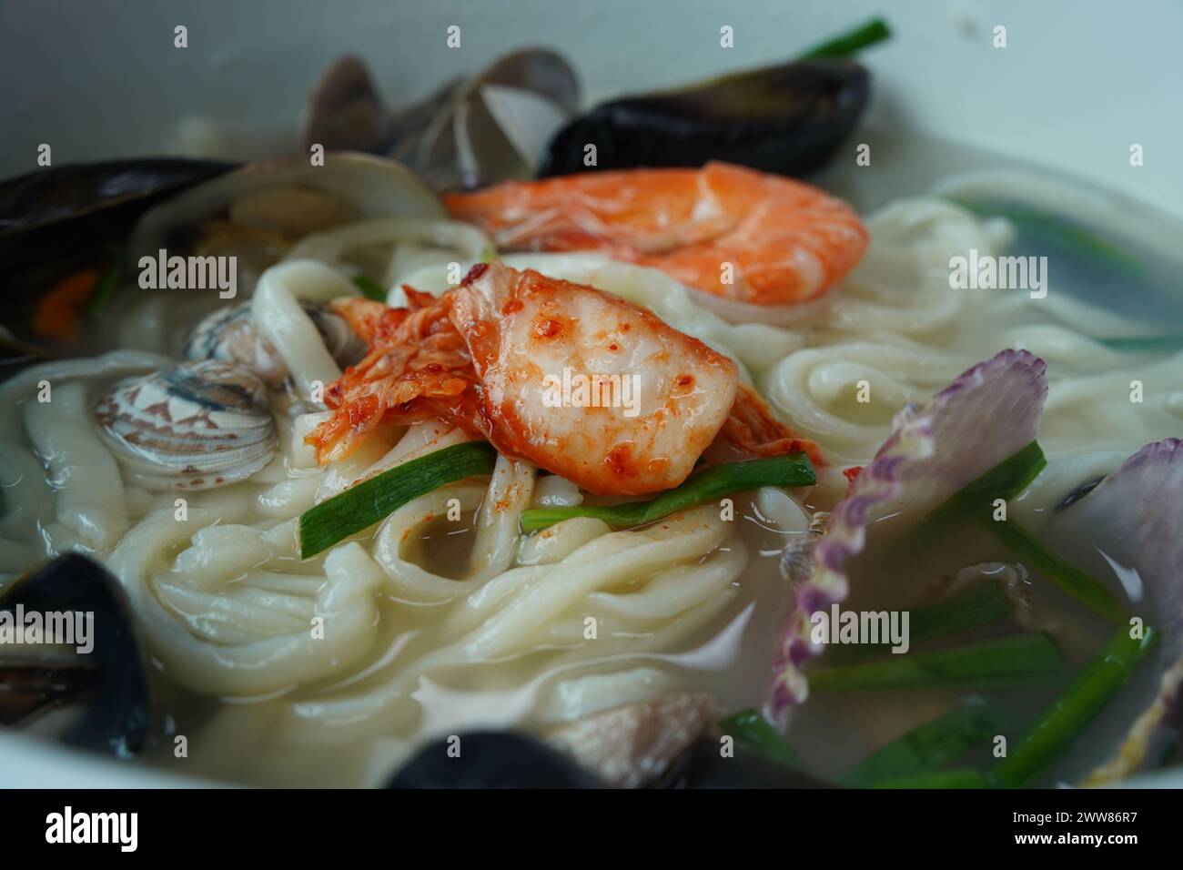Kalguksu with seafood is made by boiling thin noodles with seafood ...