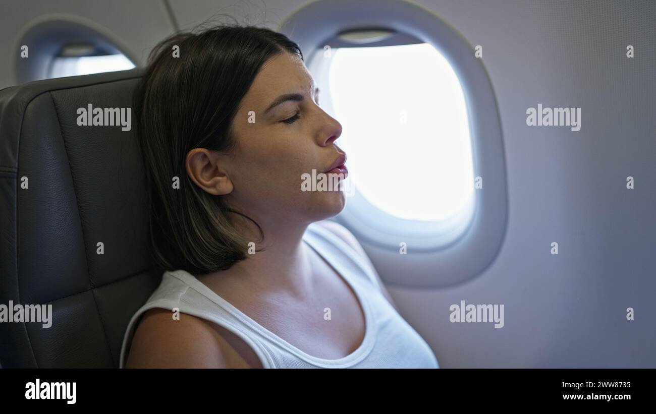 Young beautiful hispanic woman afraid of flying in the plane Stock ...
