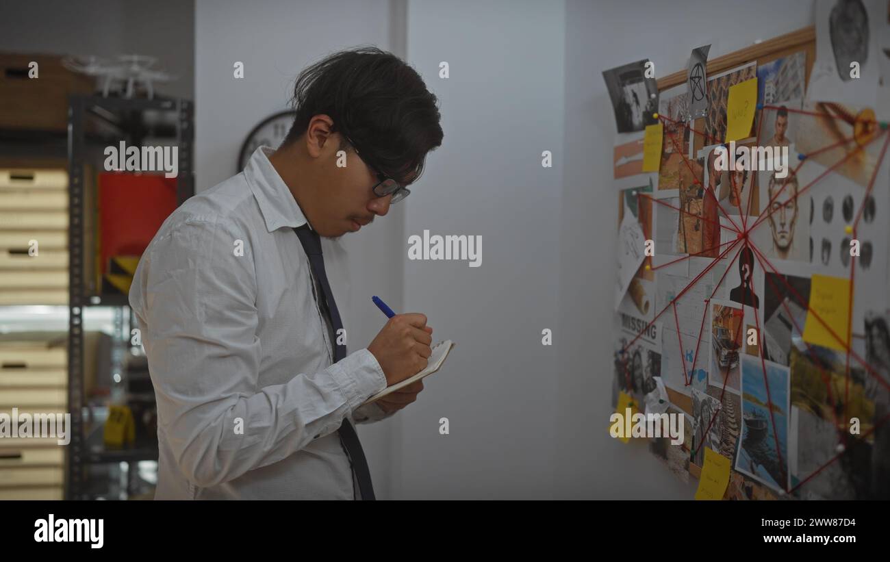 Asian man in a detective's office, taking notes in front of an ...