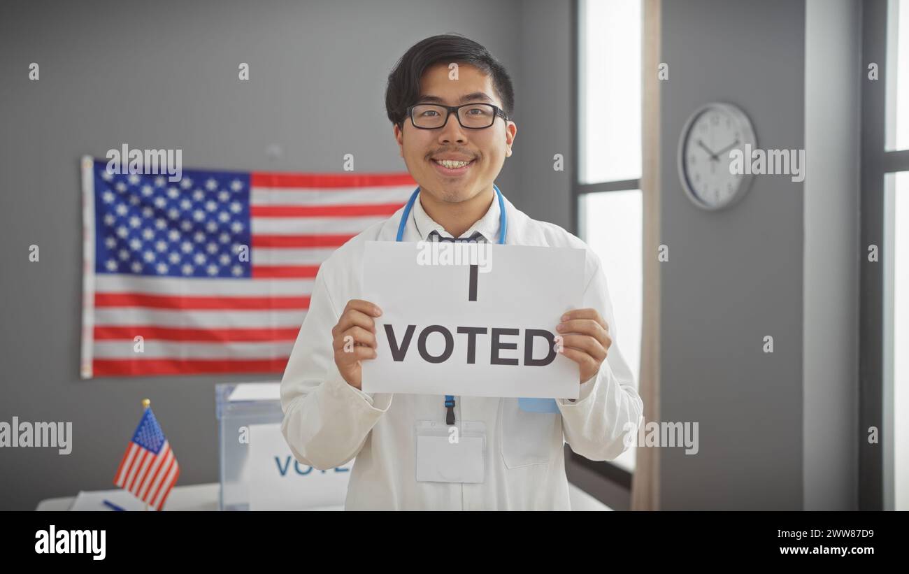 Asian man proudly displays 'i voted' sign in usa electoral center with ...