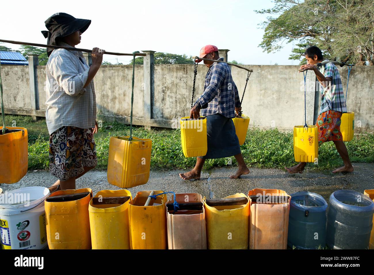 Yangon, Myanmar. 22nd Mar, 2024. Residents carry water from a lake at ...