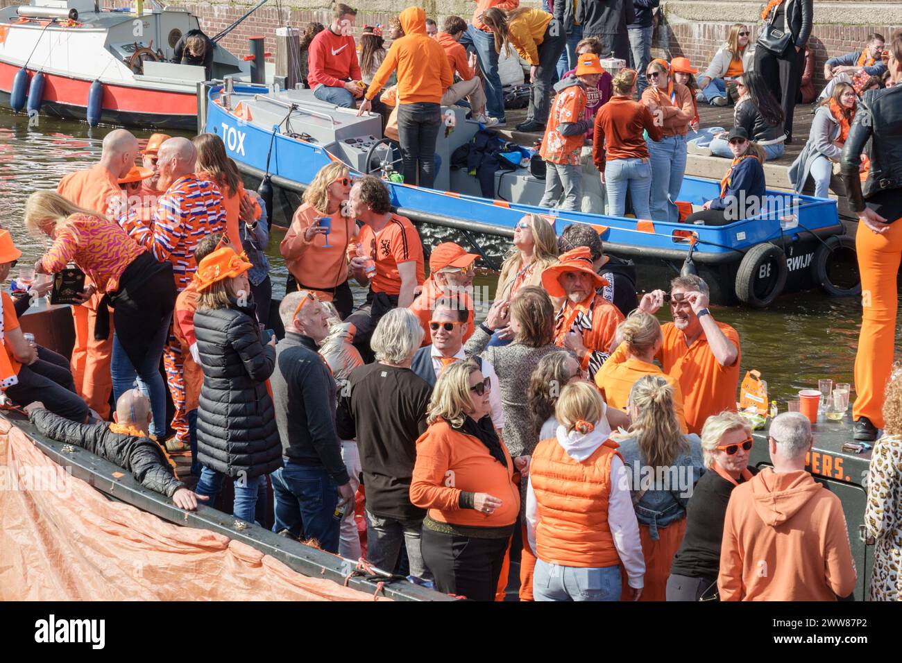Joyful Crowd Celebrating King's Day in Amsterdam on floating boat, boat ...