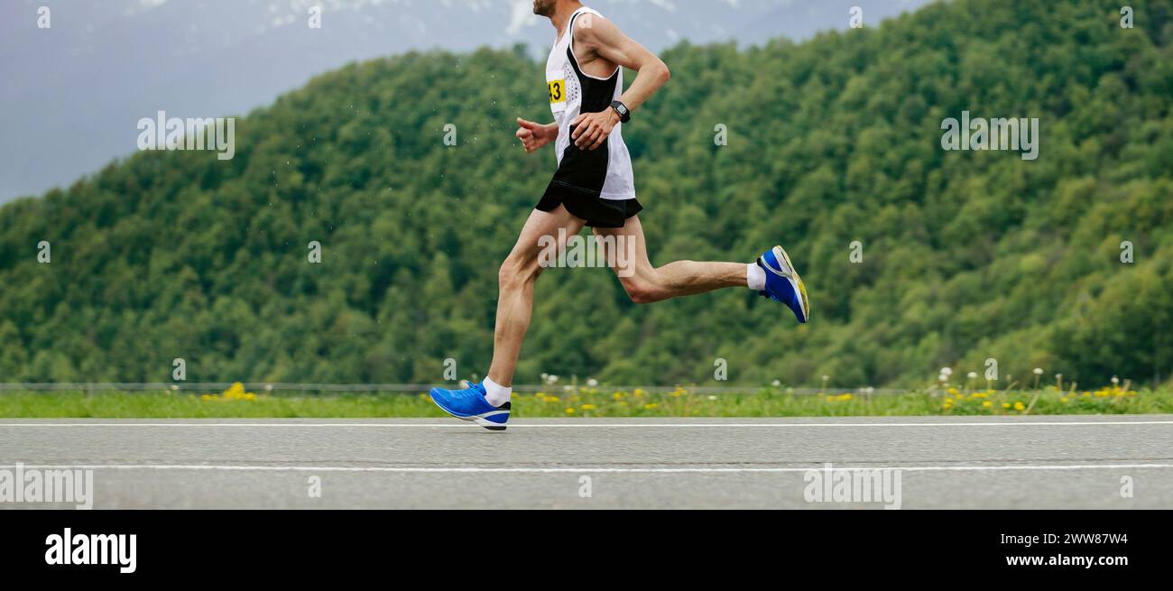 leading athlete runner running marathon race in background of mountains ...