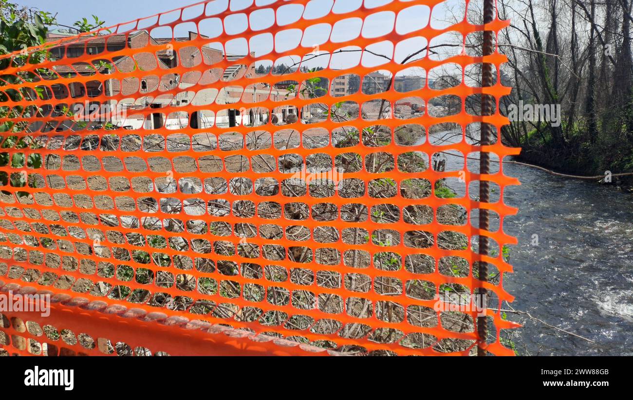 Orange plastic mesh construction site fence Italy Stock Photo - Alamy