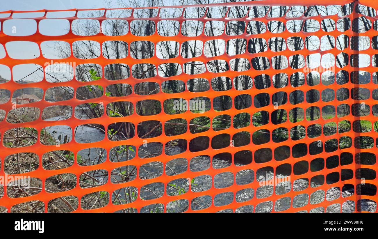 Orange plastic mesh construction site fence Italy Stock Photo - Alamy