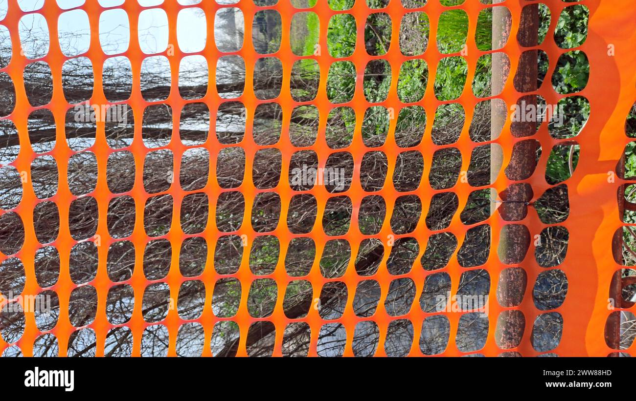 Orange plastic mesh construction site fence Italy Stock Photo - Alamy