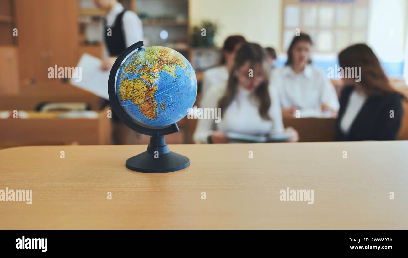 A globe of the world in a school classroom during a lesson. The globe ...