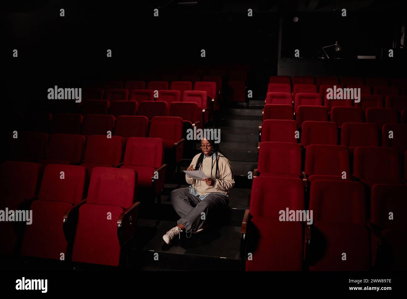 Minimal wide angle view at female African American artist rehearsing ...