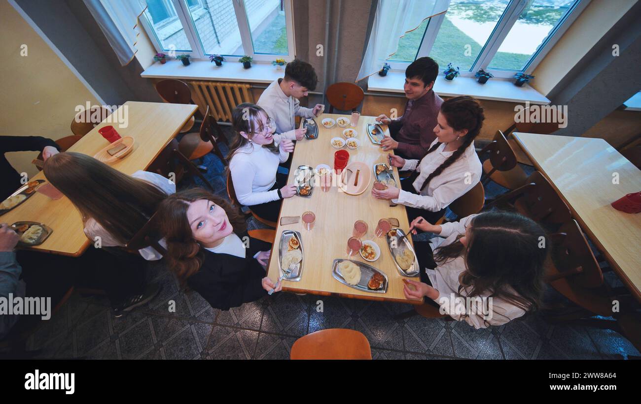 Friends eating together at canteen hi-res stock photography and images ...