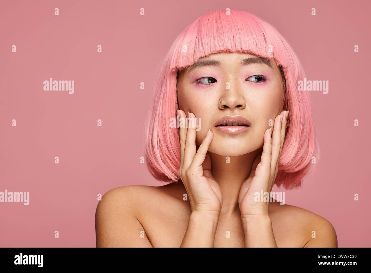 pretty asian young woman looking to side and touching her cheek with ...