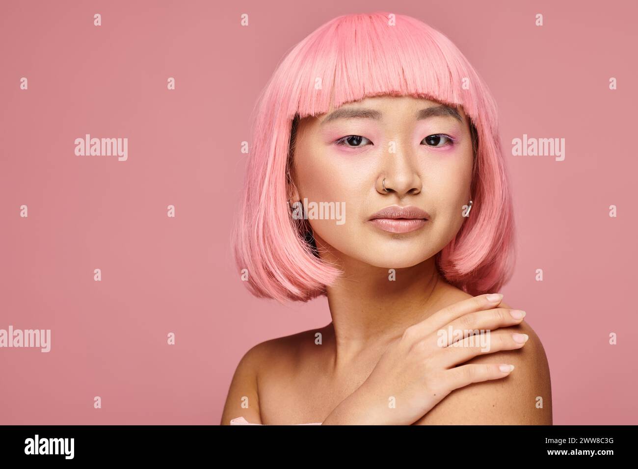 beautiful woman in 20s with pink hair and nose piercing touching ...