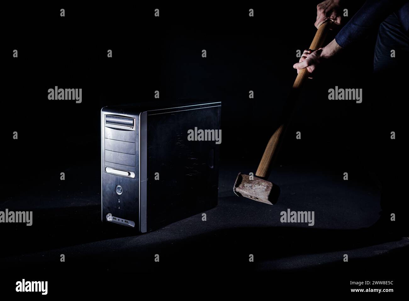 Blow of a large, heavy hammer with a long handle onto a desktop ...