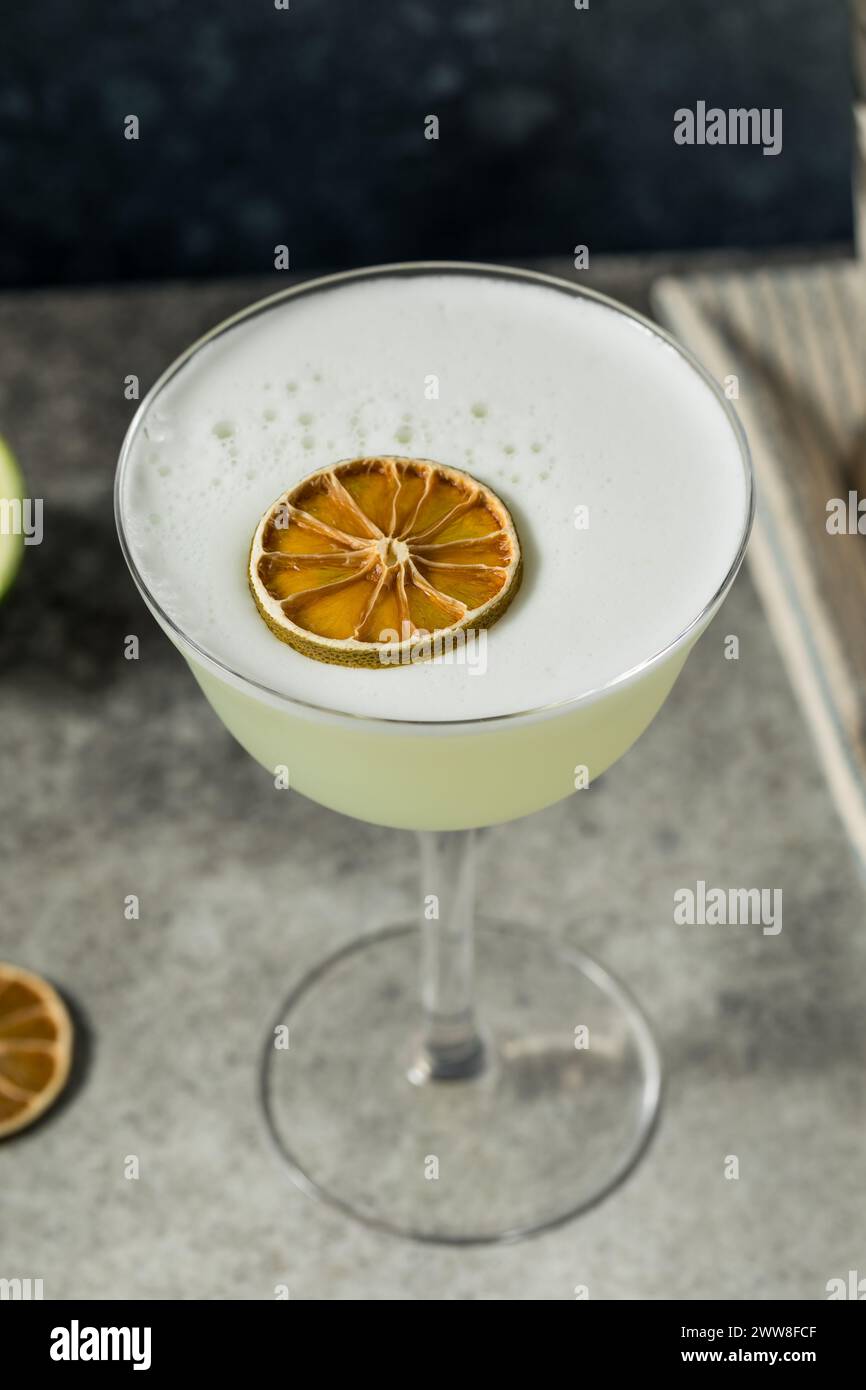 Boozy Foamy Gin Sour Cocktail with Lime and Syrup Stock Photo - Alamy