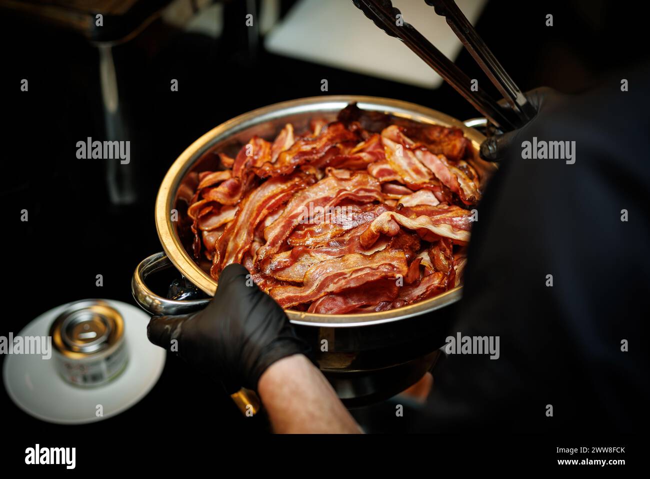 Crispy Bacon: glistening texture of dry cooked bacon in a chef hands ...