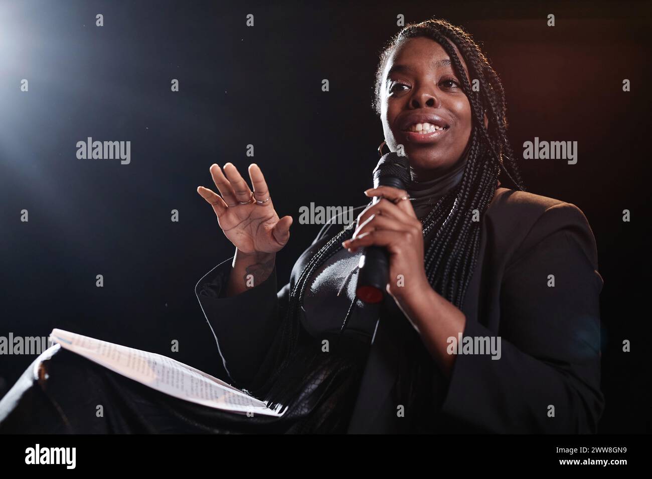 Minimal portrait of African American woman speaking to microphone on ...
