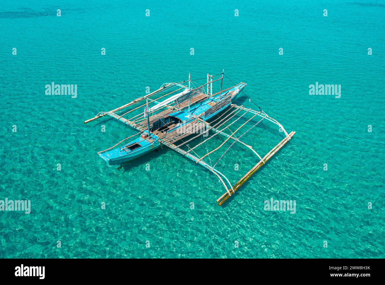 Aerial drone view of traditional philippine boat bangka anchored in the ...
