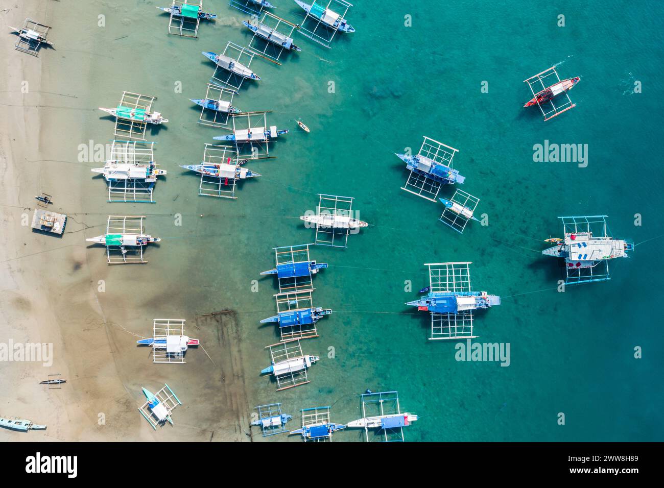 Top drone view of a traditional philippine boats on the surface of the ...
