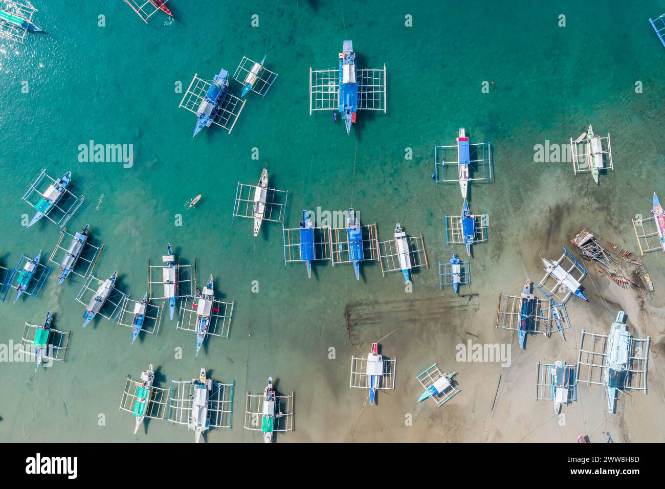 Top drone view of a traditional philippine boats on the surface of the ...